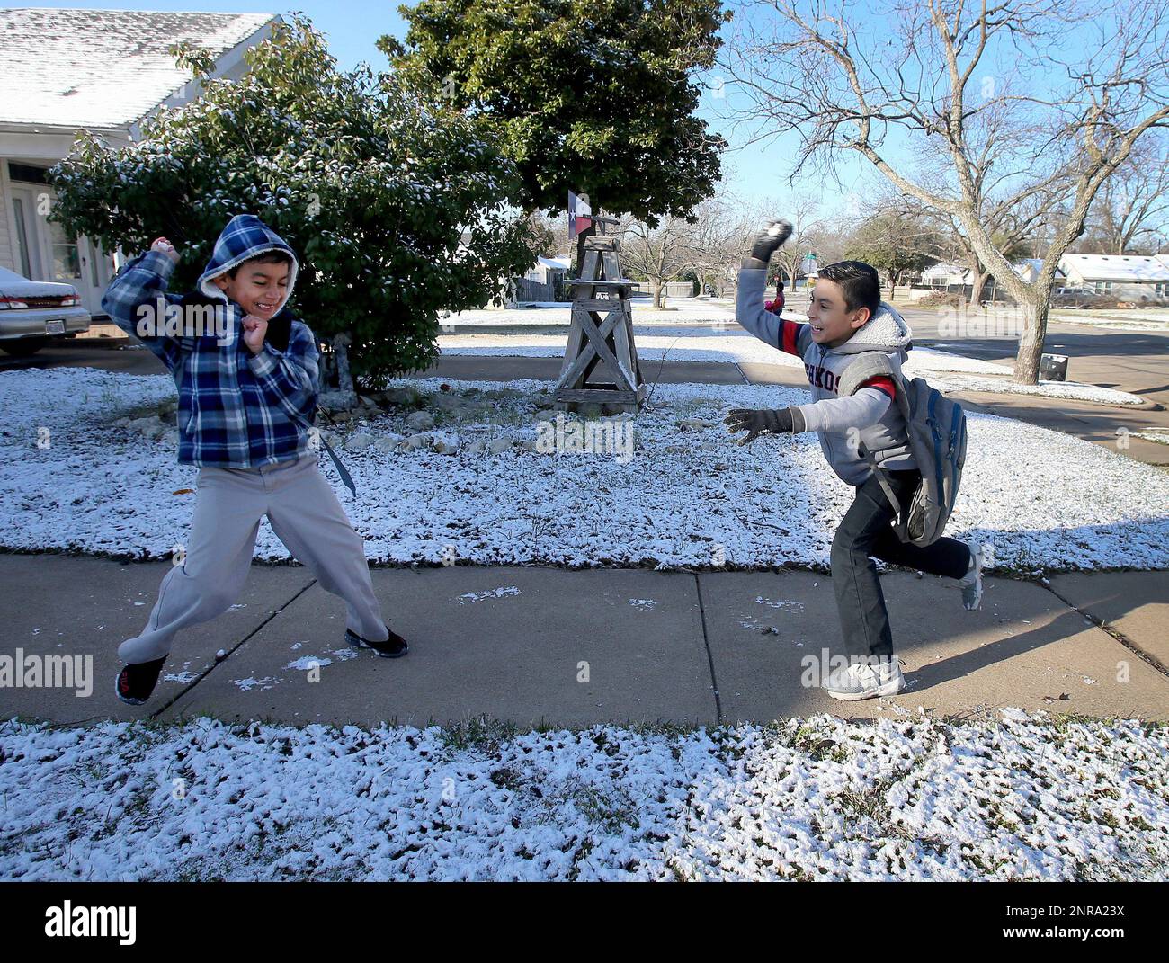 Jayden Barrientos, left, and his brother Gustin play in the snow ...