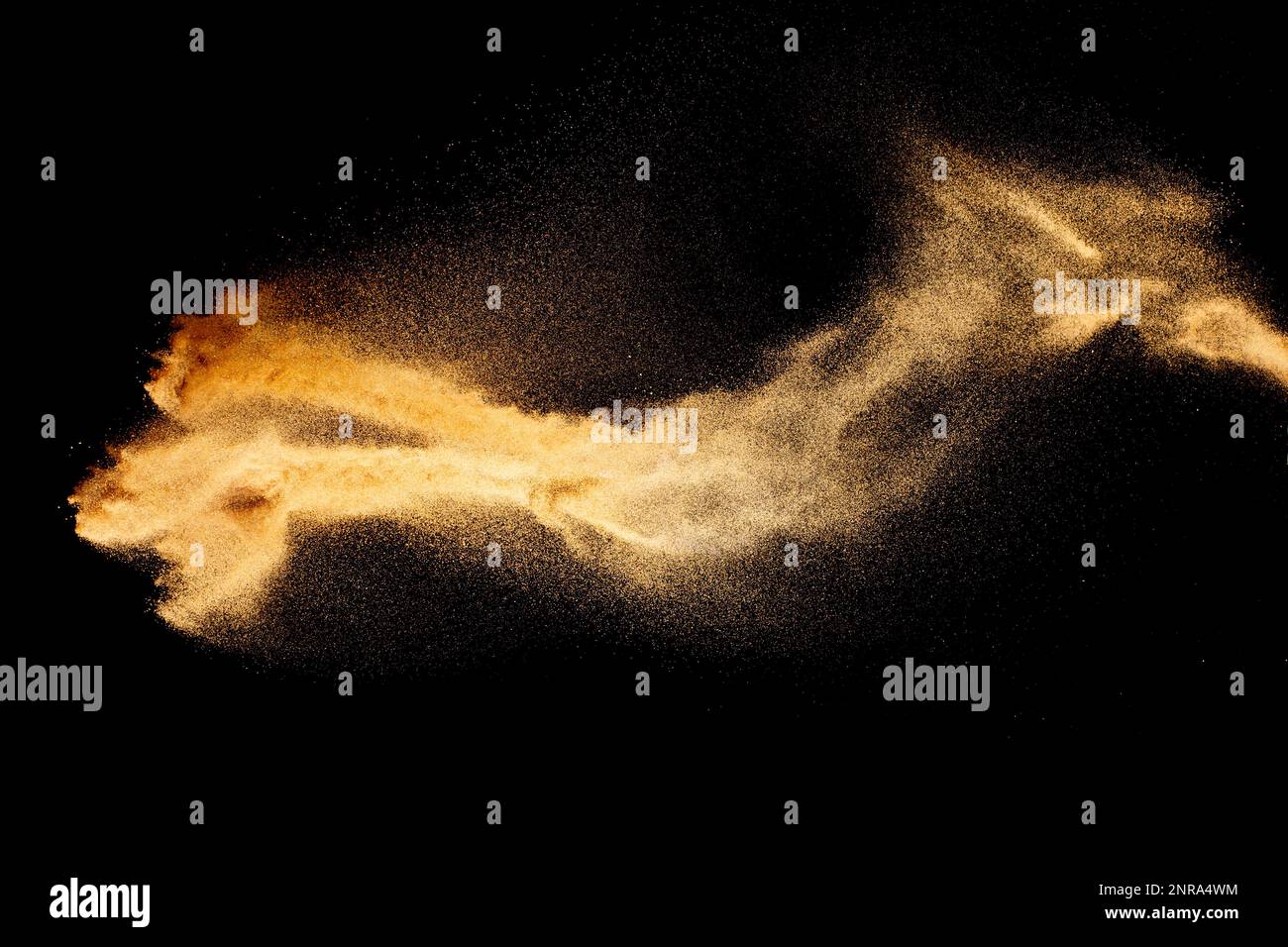 Sand explosion isolated on black background. Freeze motion of sandy ...