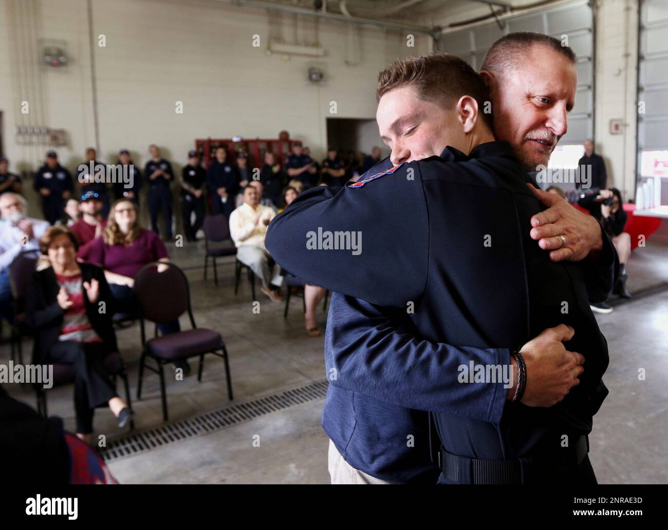 Kenny Adams, right, hugs his son Payton Adams as Payton becomes one of ...