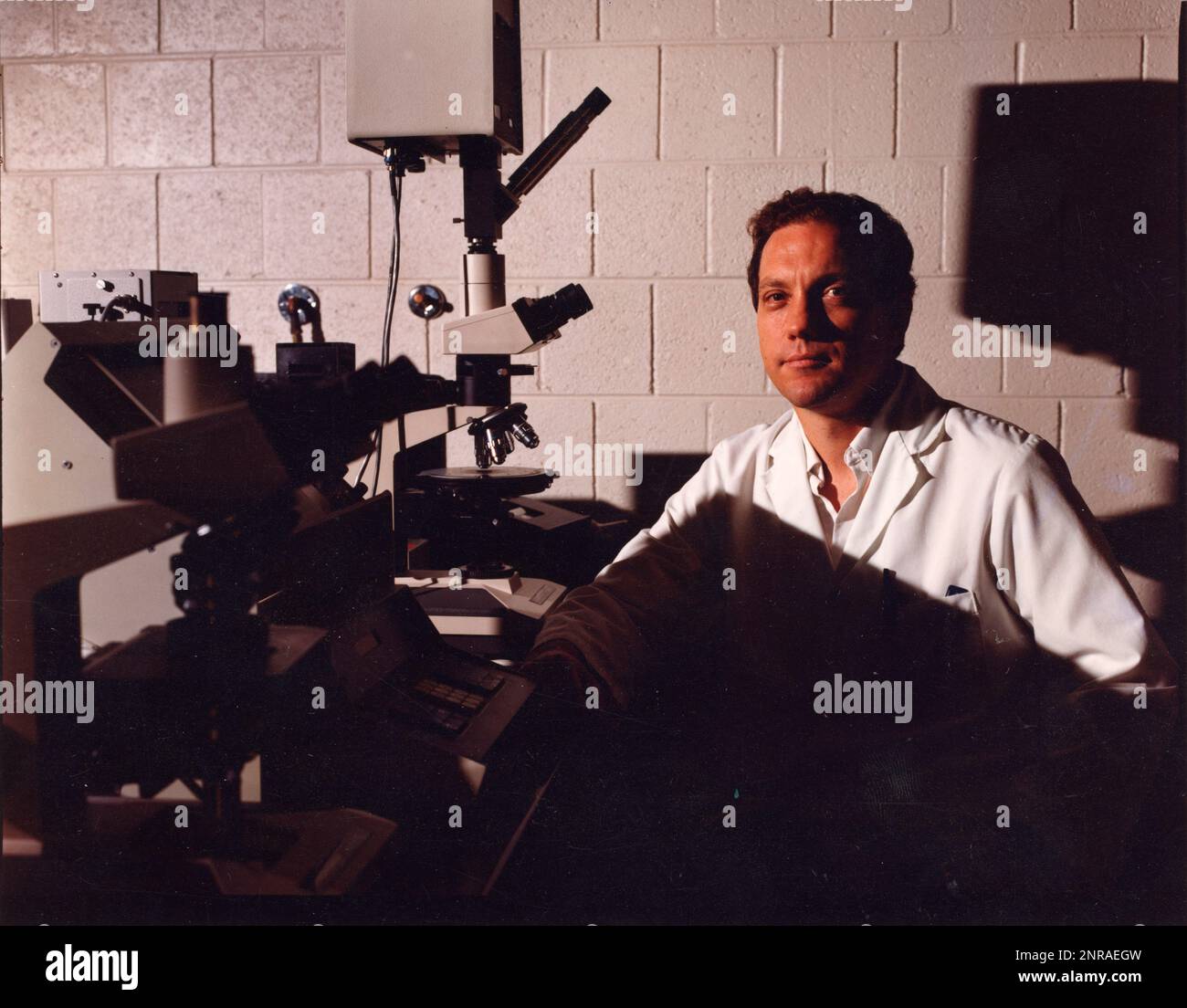 Larry Peterson in the crime lab with the microscope that was used to ...