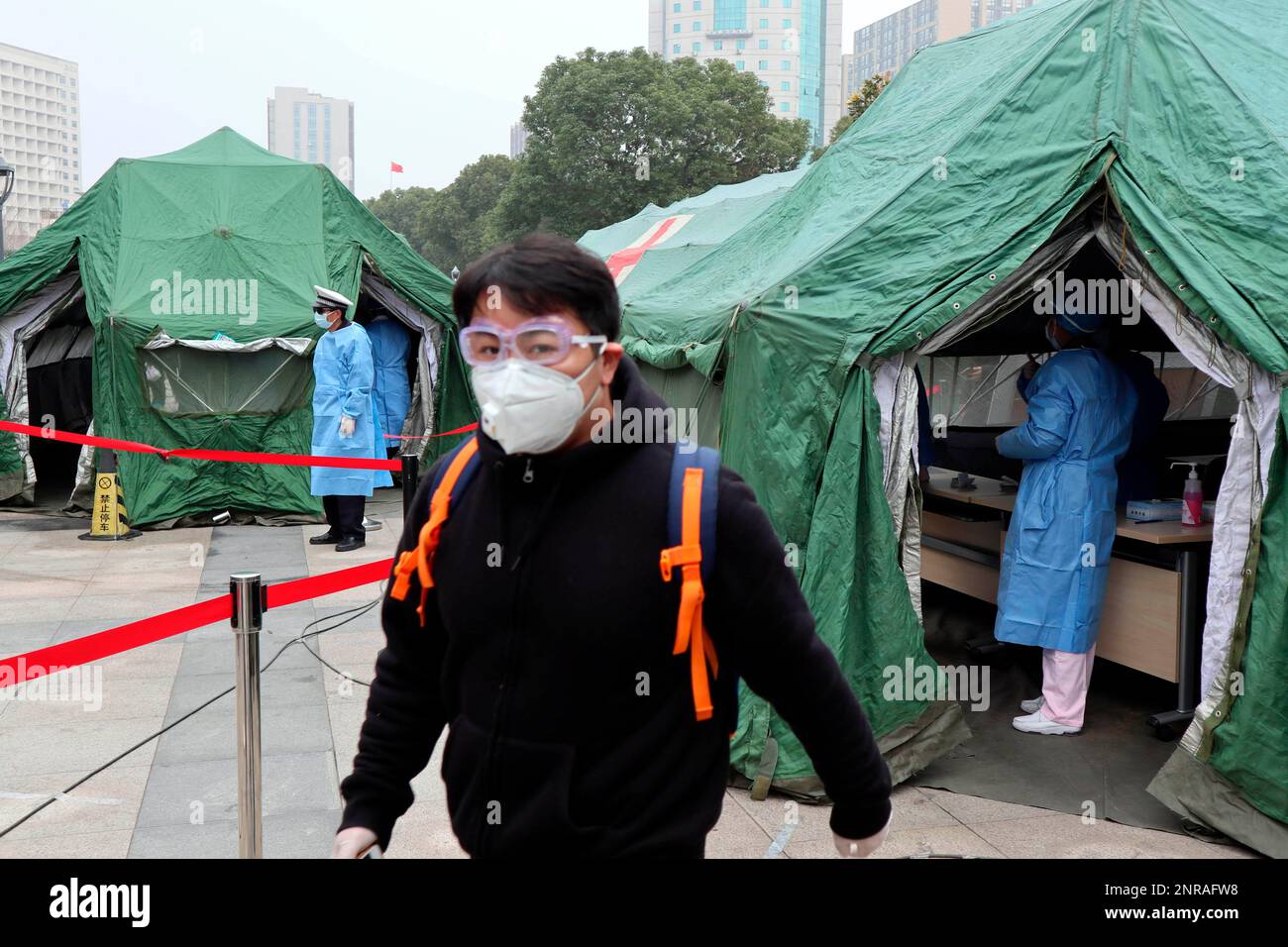 A visitor walks out a tent after a brief check by the medical staff ...