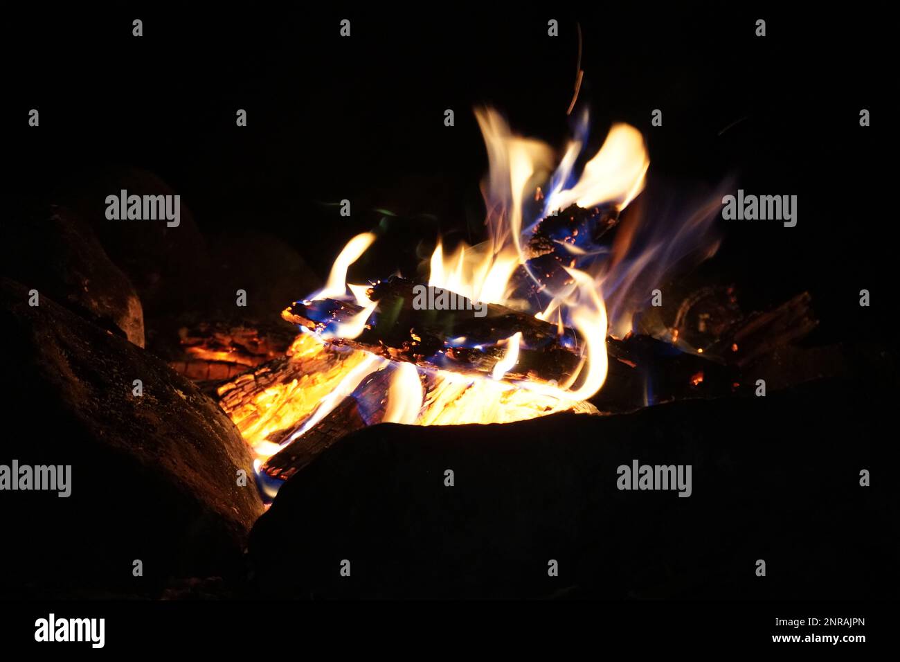 Camp fire flames dance in the night Stock Photo - Alamy