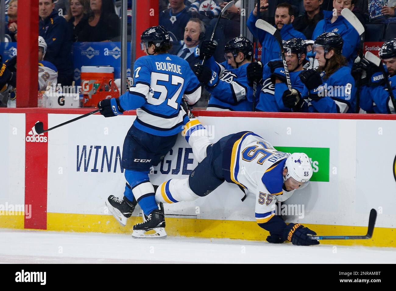 Winnipeg Jets' Gabriel Bourque (57) checks St. Louis Blues' Colton ...