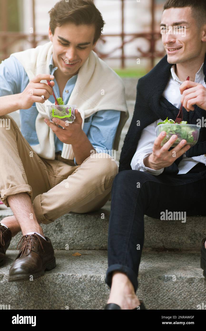 Two happy men with healthy food outdoors Stock Photo - Alamy