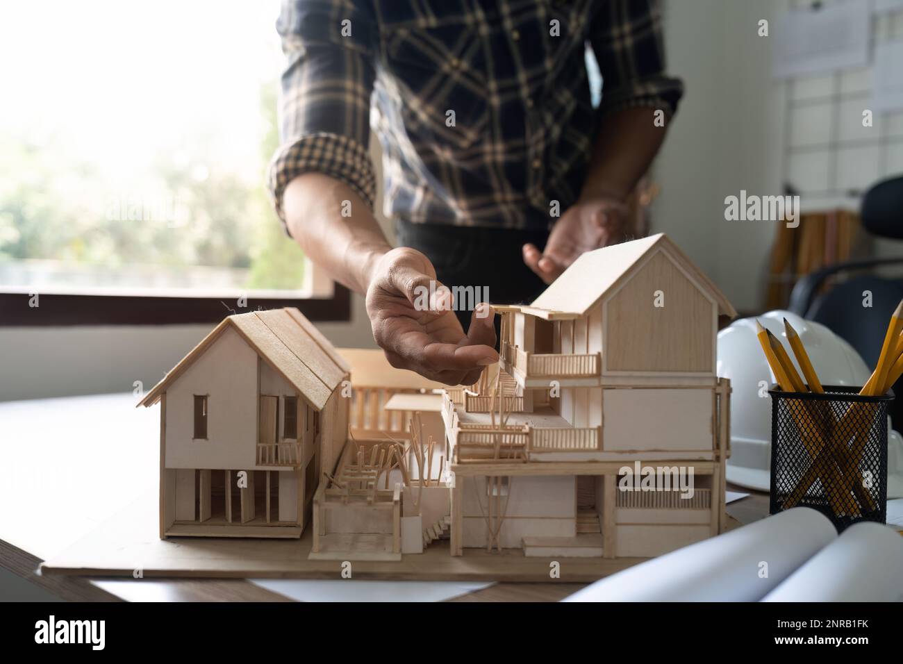 architect working and discussing about an architecture model together ...
