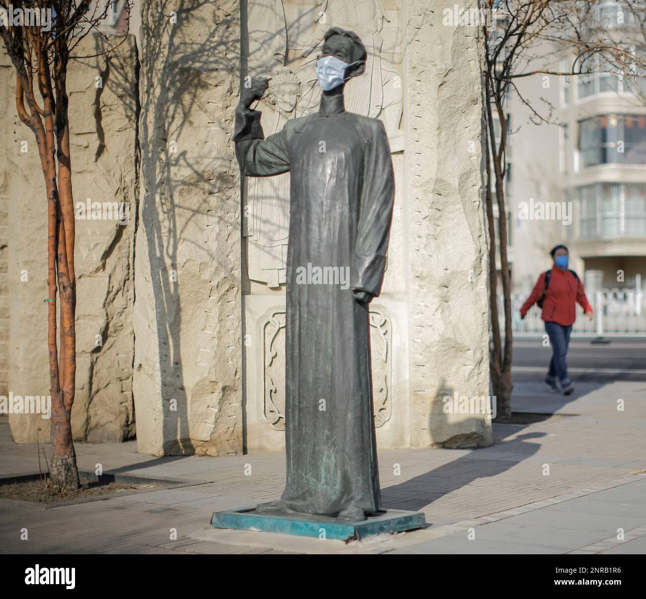 A view of the statue of Ma Sanli, which has been put on a medical mask ...