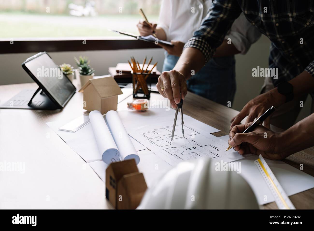 engineer and architect people meeting working and hand drawing on ...