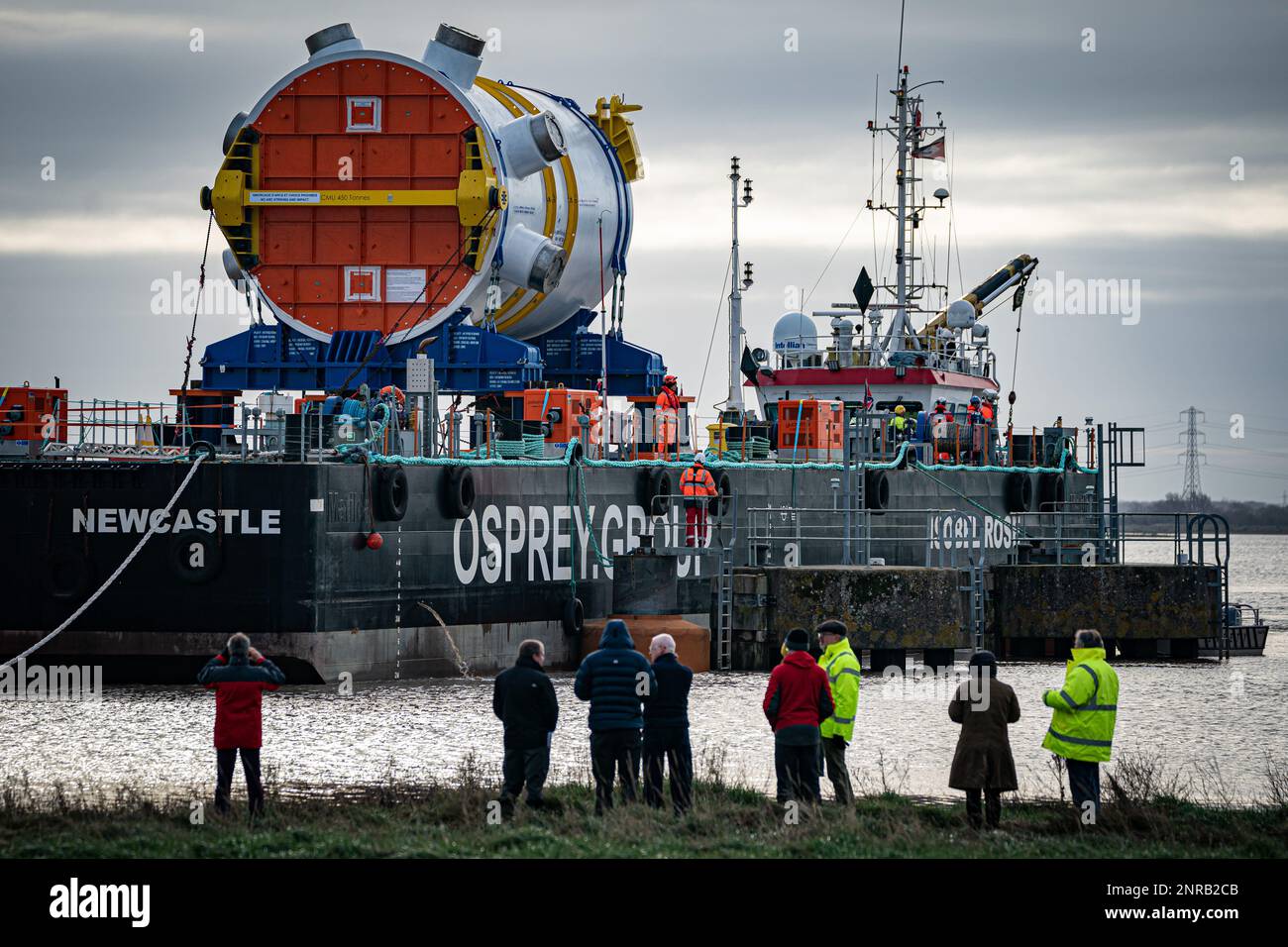 People watch as the first new nuclear reactor for a British power ...