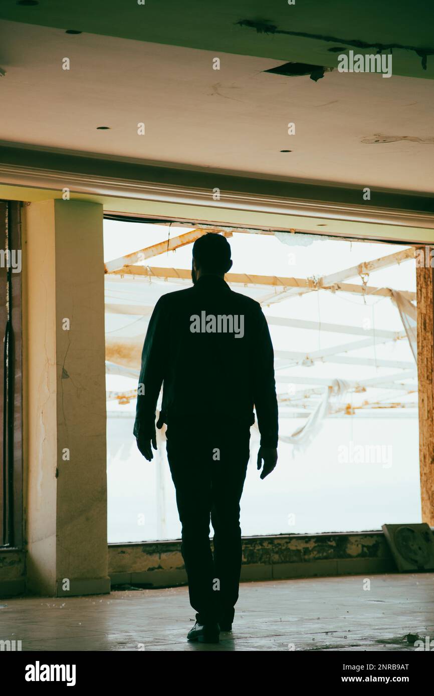 Back view man walking alone shadow hi-res stock photography and images ...