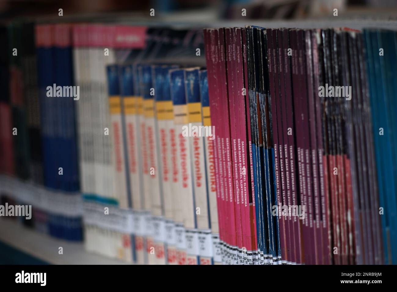 Various Textbooks Neatly Arranged On Iron Shelves, From Inside The ...