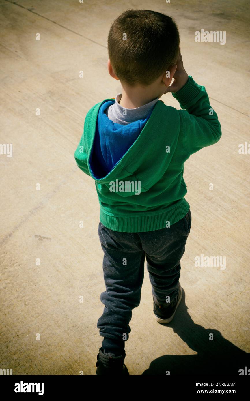 High angle rear view of boy walking away Stock Photo - Alamy