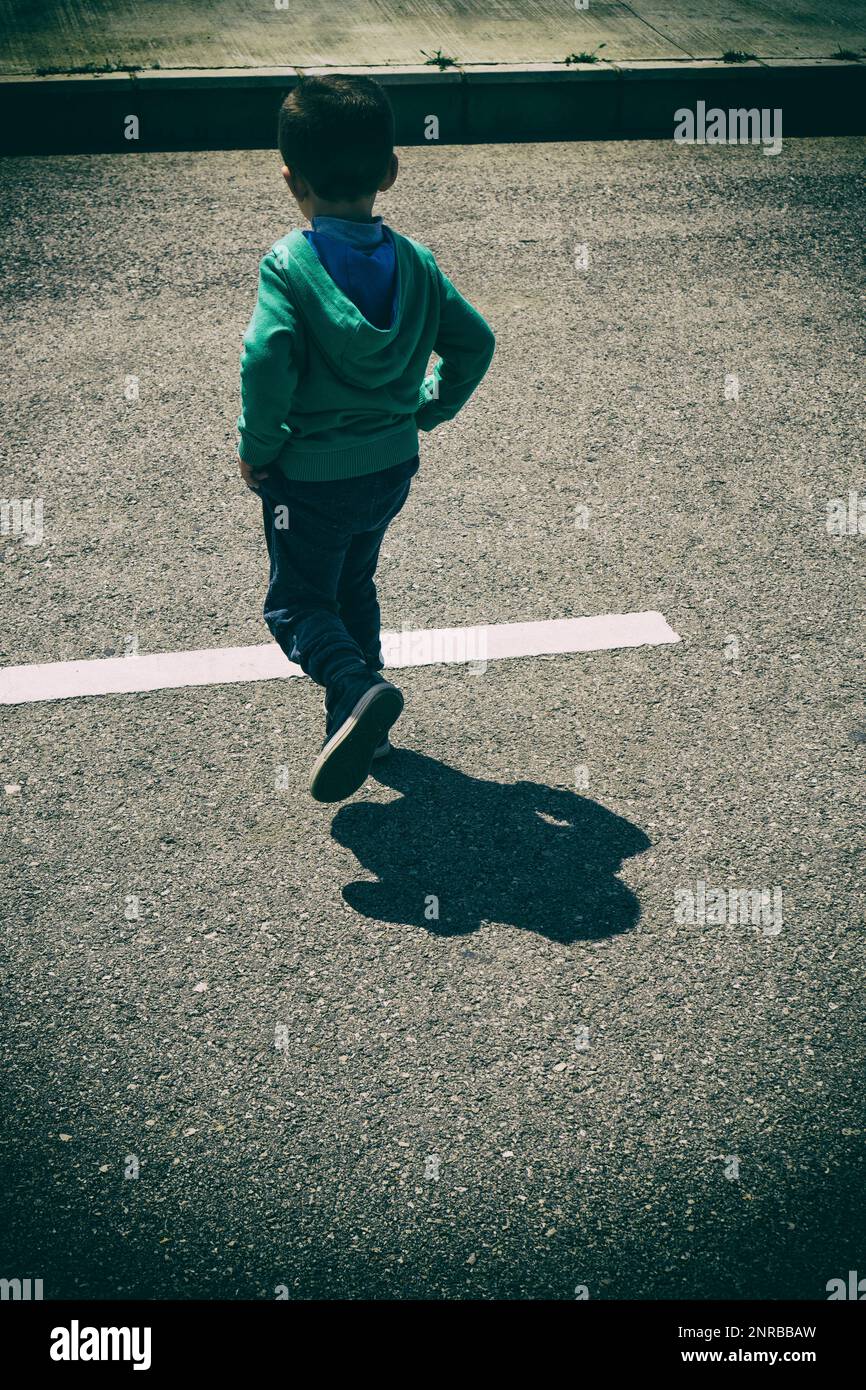 Rear view of little boy walking away Stock Photo - Alamy