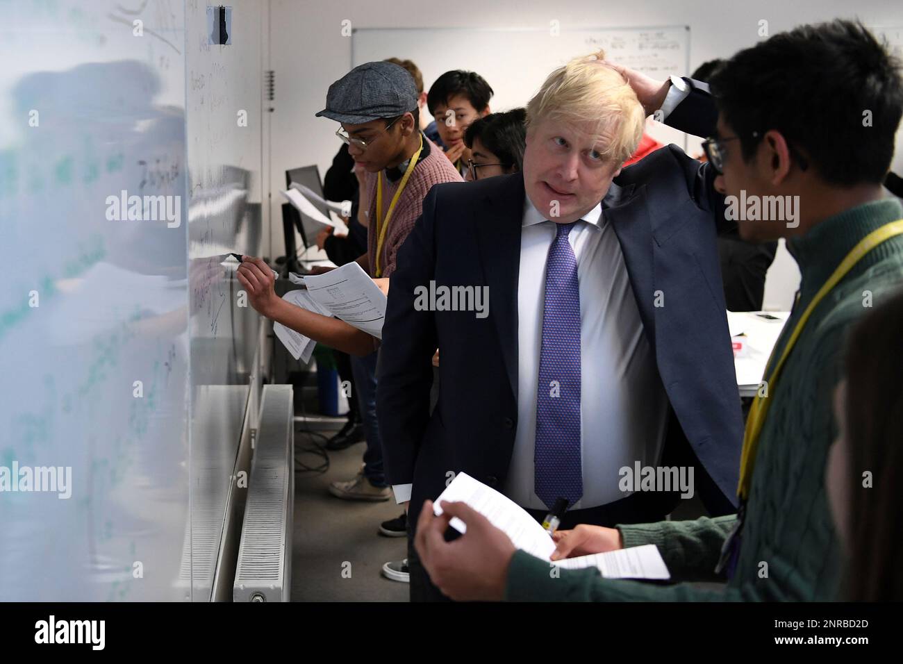 Britain's Prime Minister Boris Johnson, center, visits the Department ...