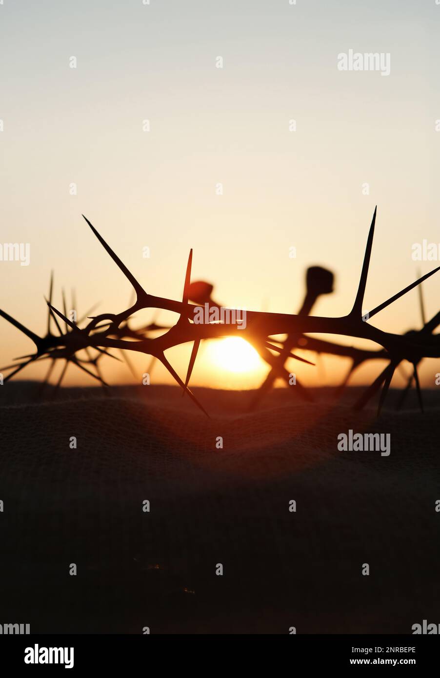 The cross, crown of thorns, nails and red sunset symbolizing the ...