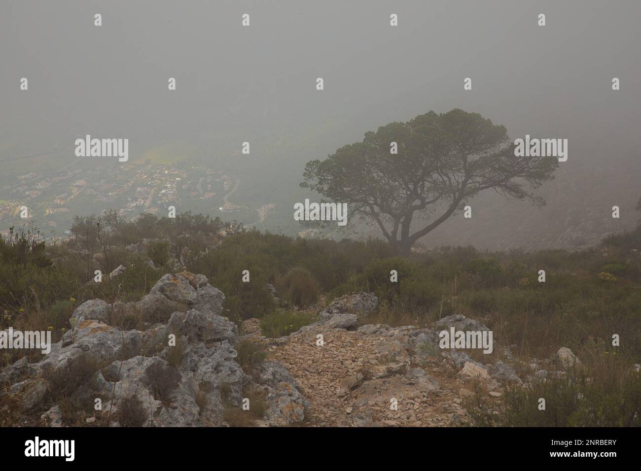 A hazy view of Montgó mountain in Spain with its cliffy, green ...