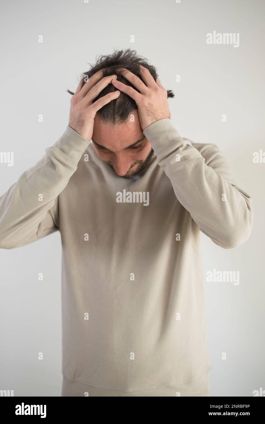 Stressed man head in hands Stock Photo - Alamy