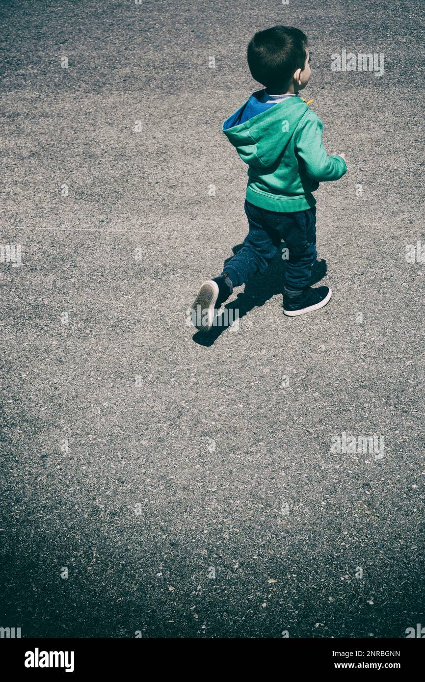 Boy running away on the street Stock Photo - Alamy