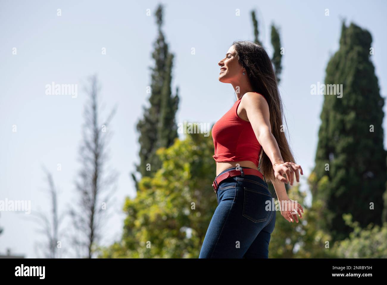 Side view of happy woman arms outstretched Stock Photo - Alamy