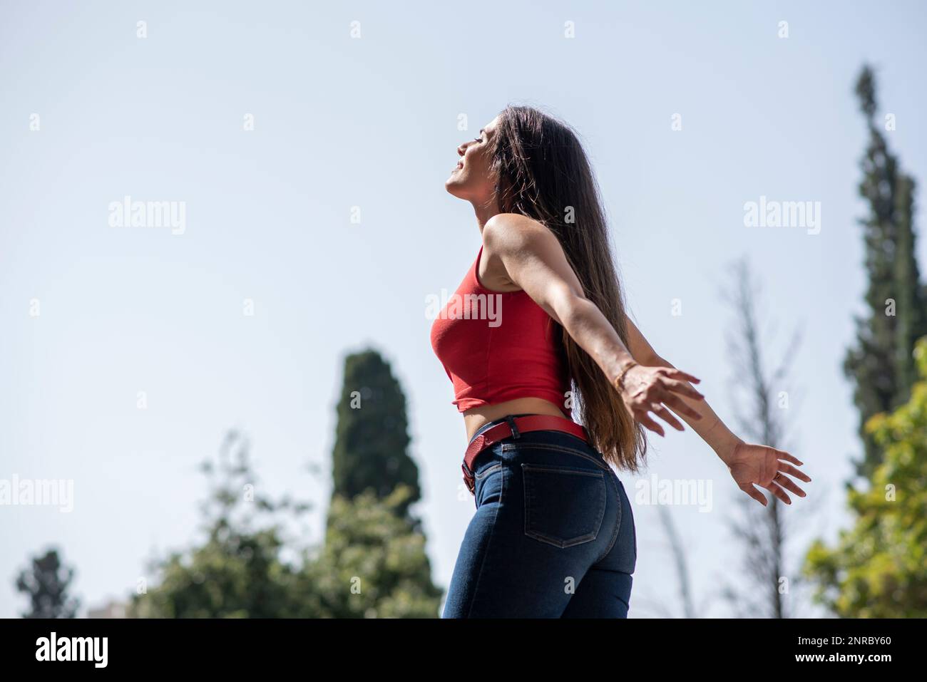 Side view of happy woman arms outstretched Stock Photo - Alamy