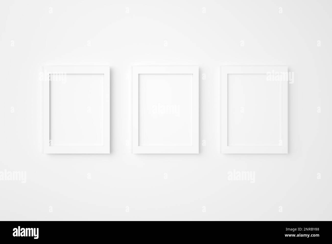 Three blank or empty rectangle picture frames hanging on white wall ...