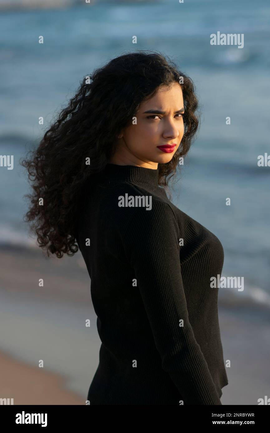 Serious woman staring on the beach Stock Photo - Alamy