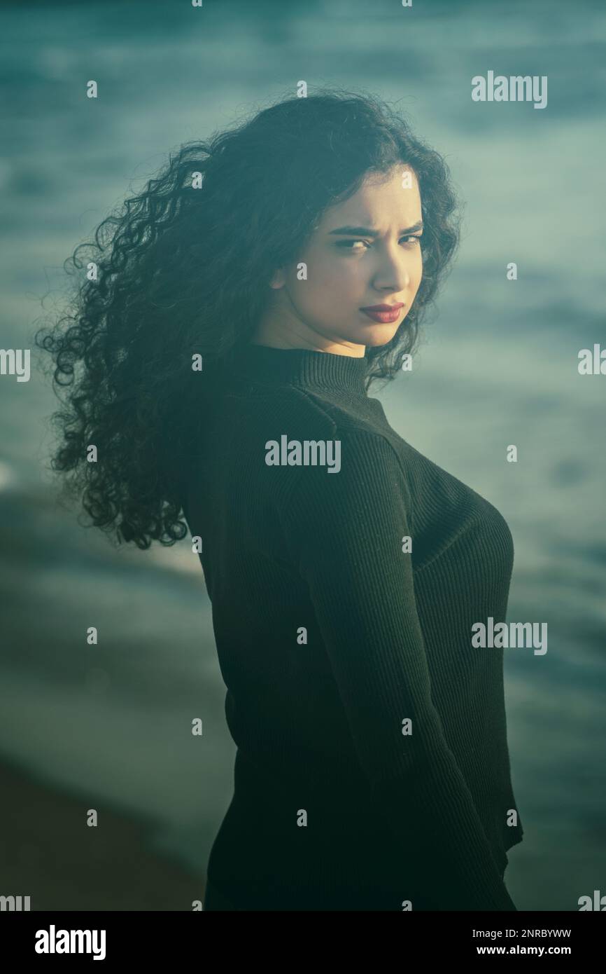 Serious woman looking over shoulder Stock Photo - Alamy