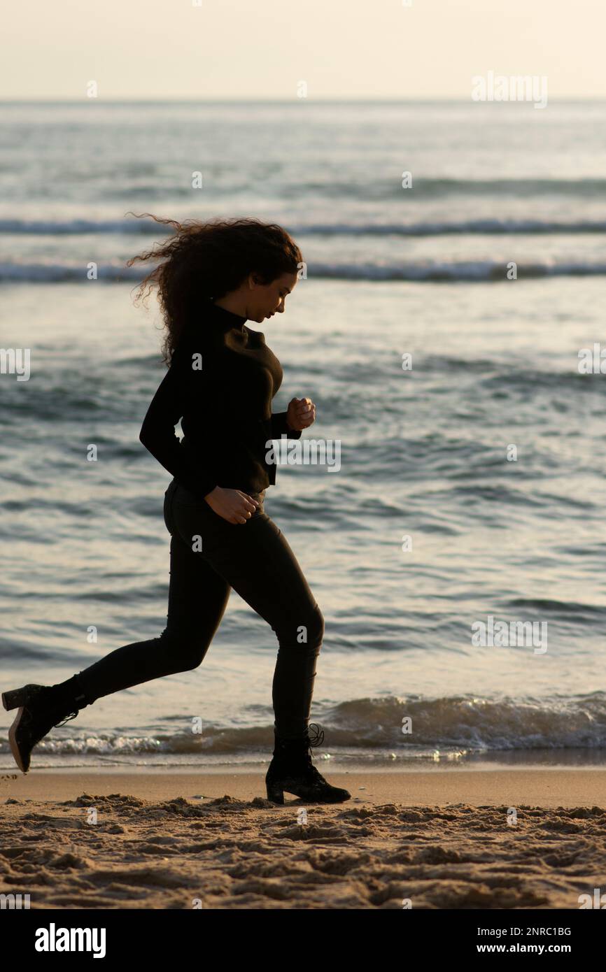 Young woman running away profile hi-res stock photography and images ...