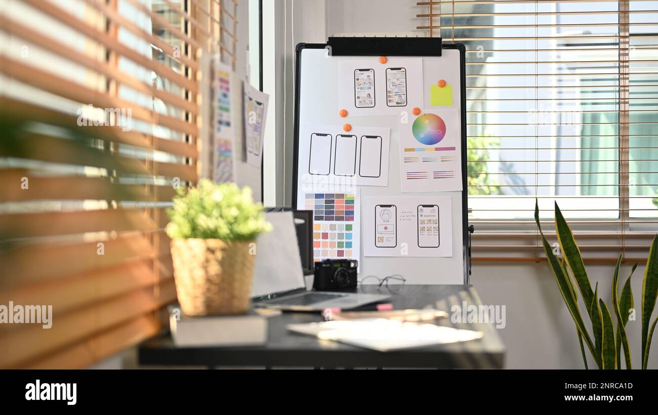 Creative office with laptop, stationery and wireframe sketches of ...