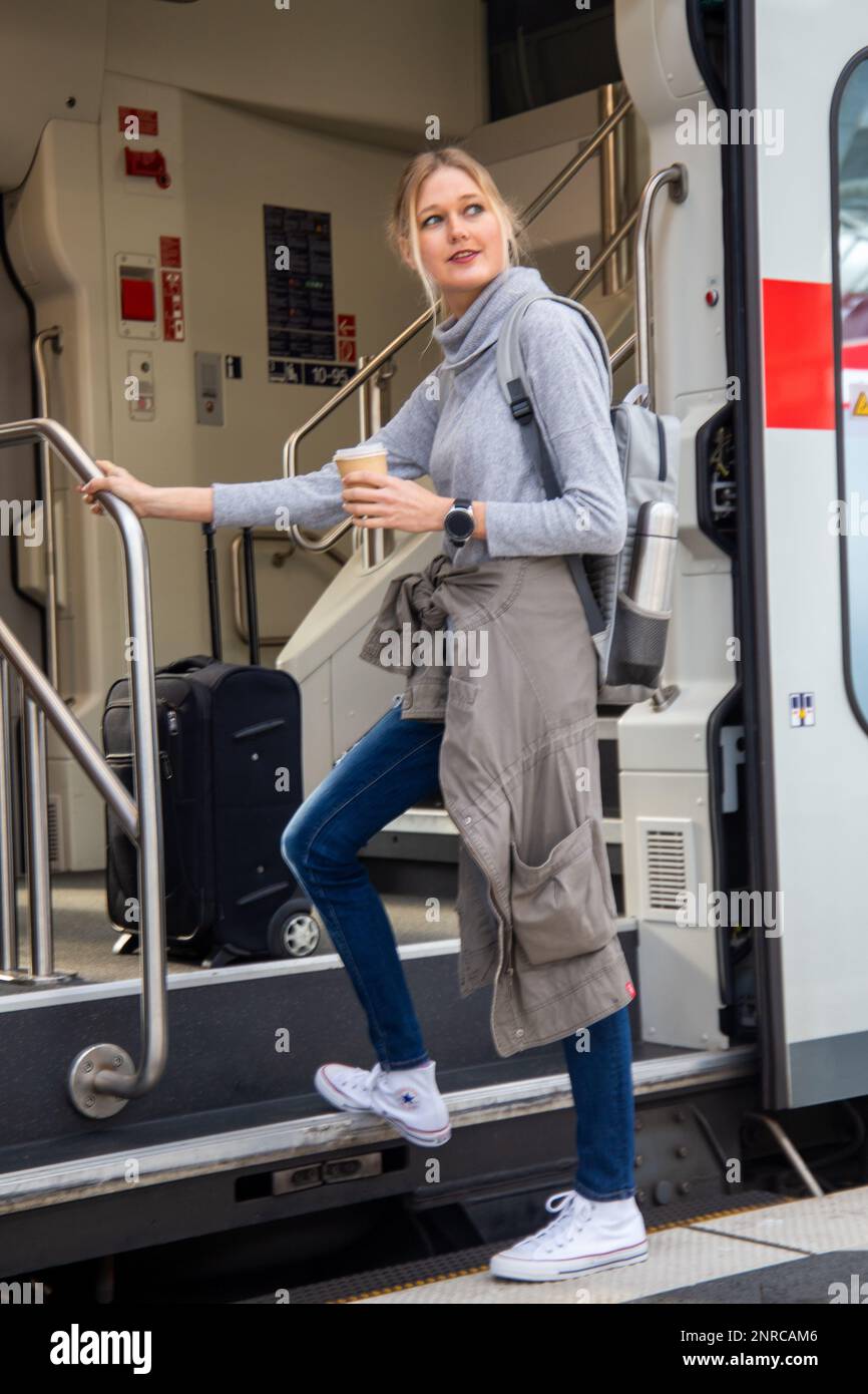 Young woman gets on a Deutsche Bahn Intercity train (Model released ...