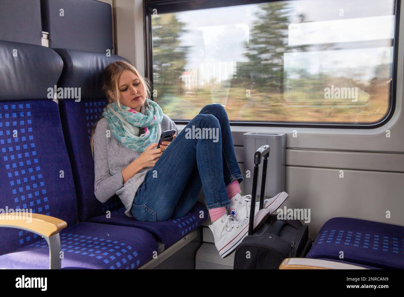 Young woman with white Chucks in a train (Model released Stock Photo ...
