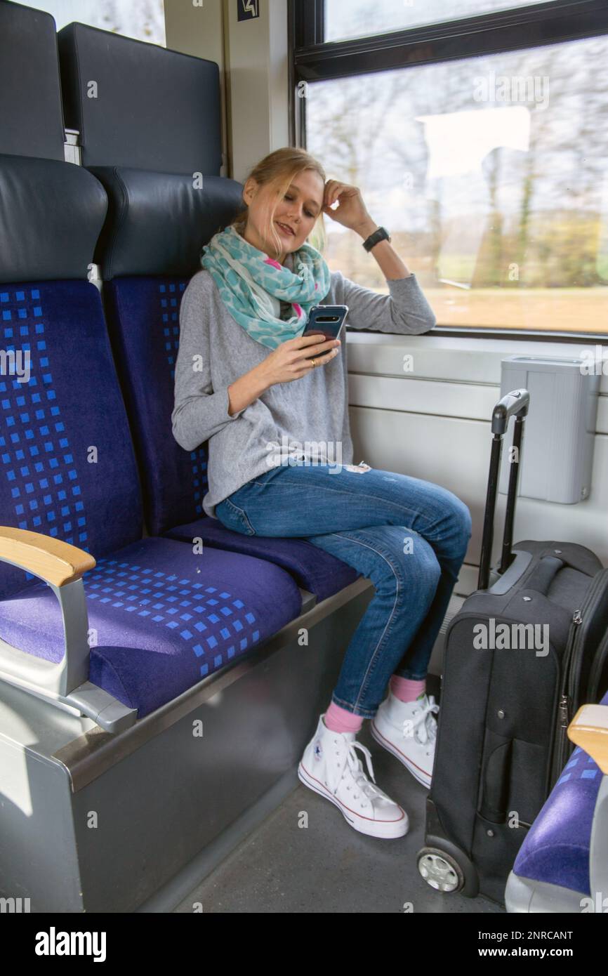 Young woman with white Chucks in a train (Model released Stock Photo ...