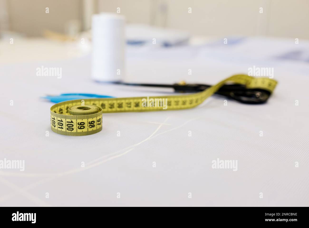 tailor's working tools - measuring tape, scissors and thread ...