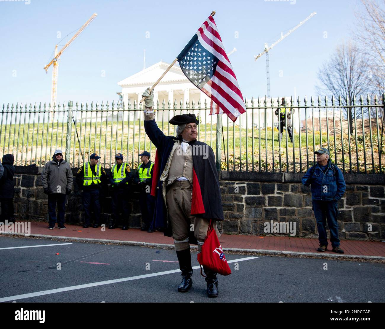 James Renwick Manship holds a United States flag upside down during a ...