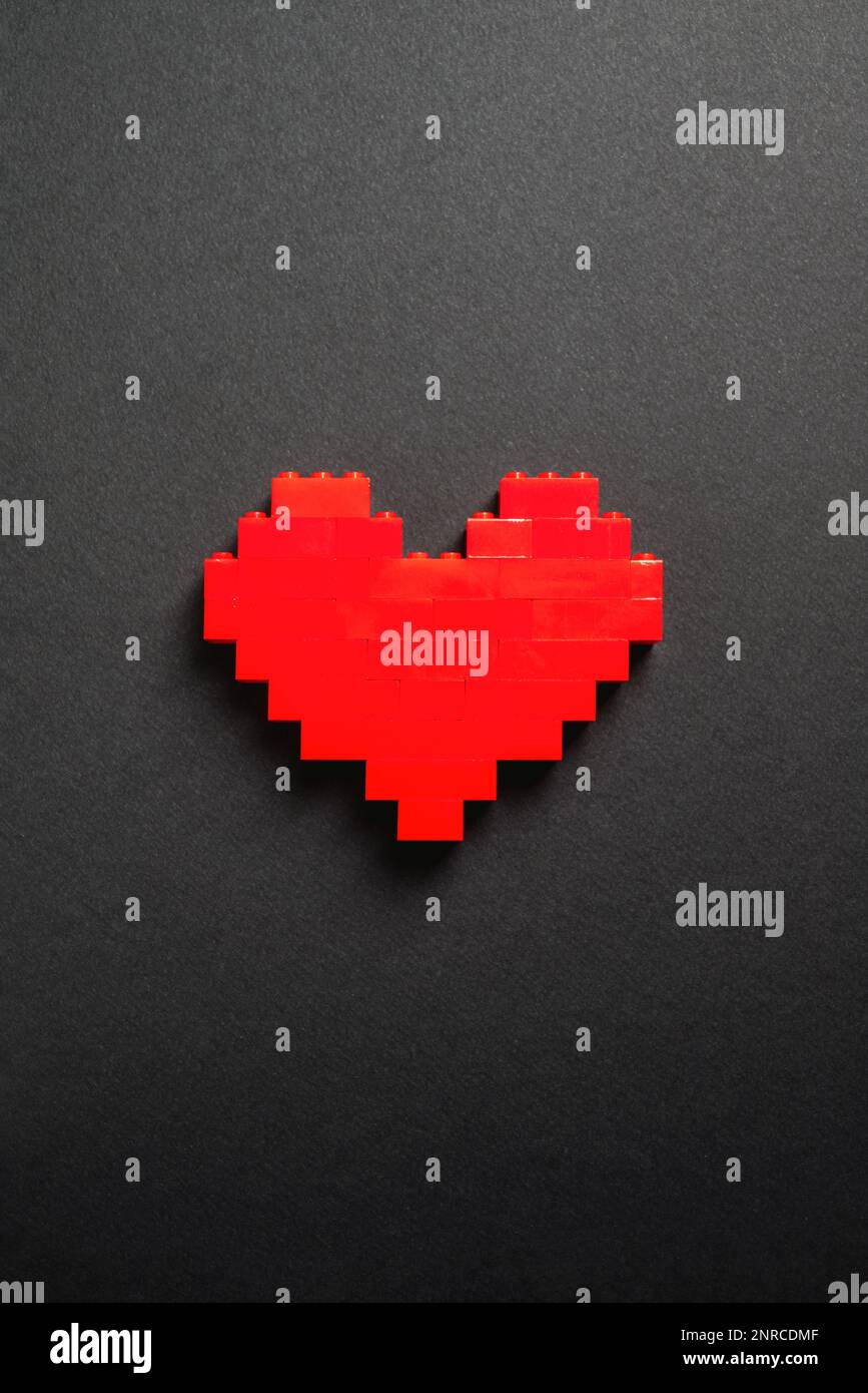 Red heart made of plastic bricks on a dark gray background Stock Photo ...