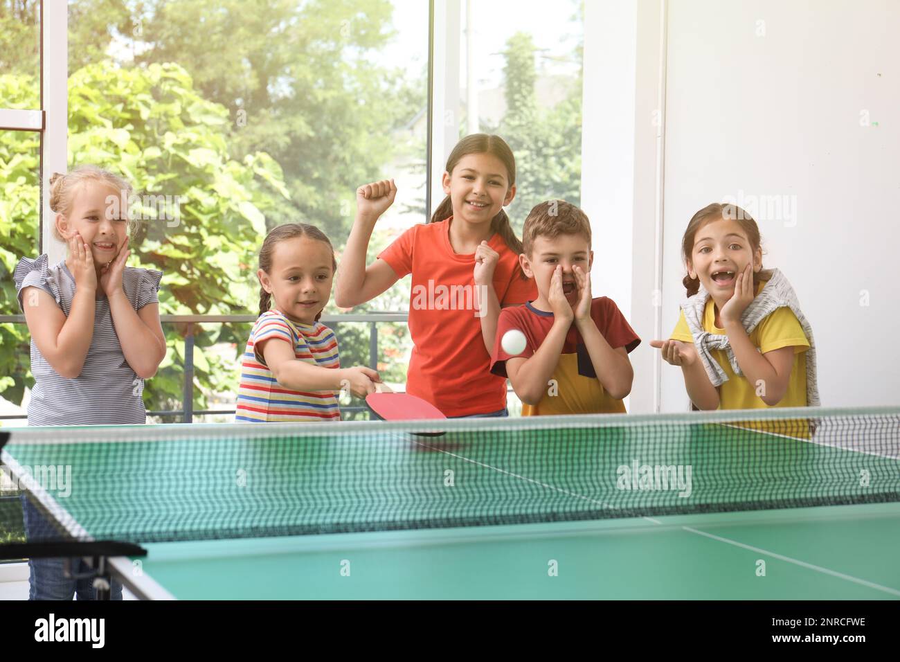 Cute happy children playing ping pong indoors Stock Photo - Alamy