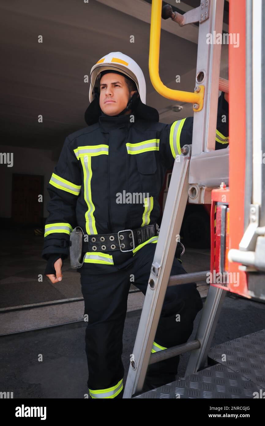 Fireman uniform helmet climbing ladder hi-res stock photography and ...