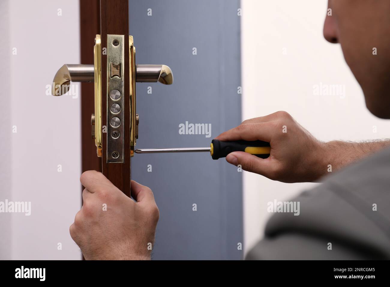 Closeup professional locksmith installing hi-res stock photography and ...