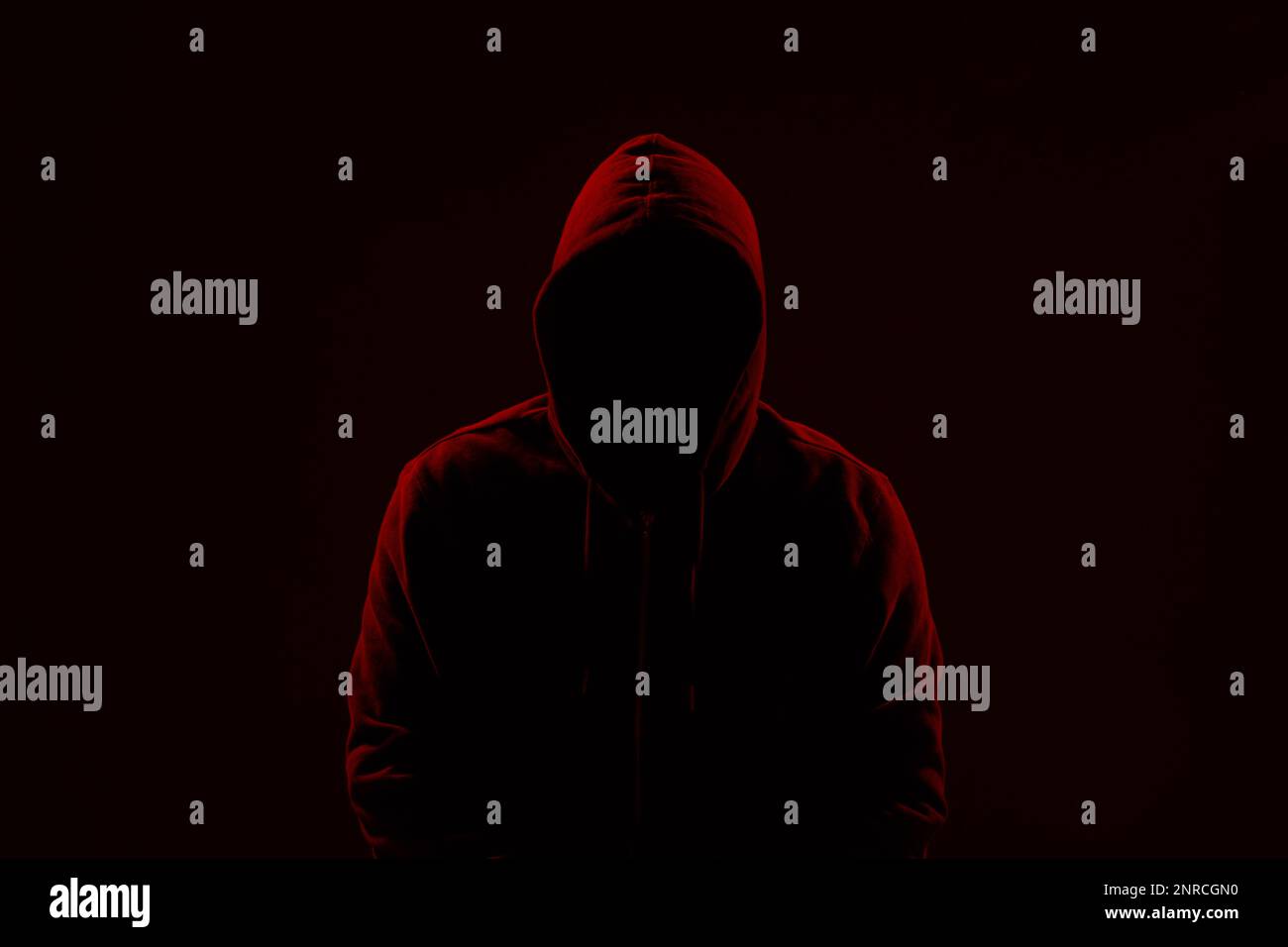 Silhouette of anonymous man on dark background, toned in red Stock ...