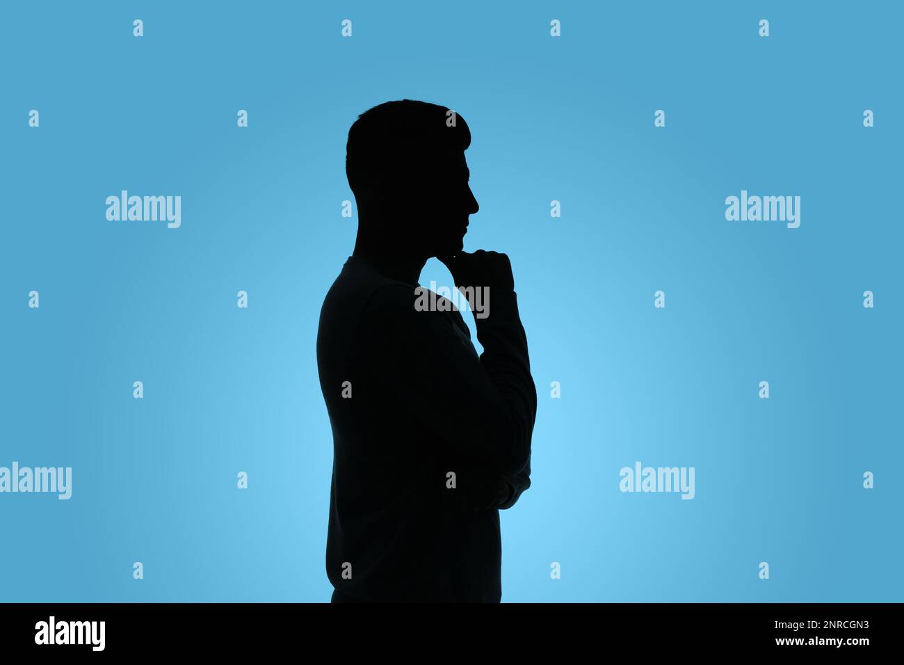 Silhouette of anonymous man on light blue background Stock Photo - Alamy