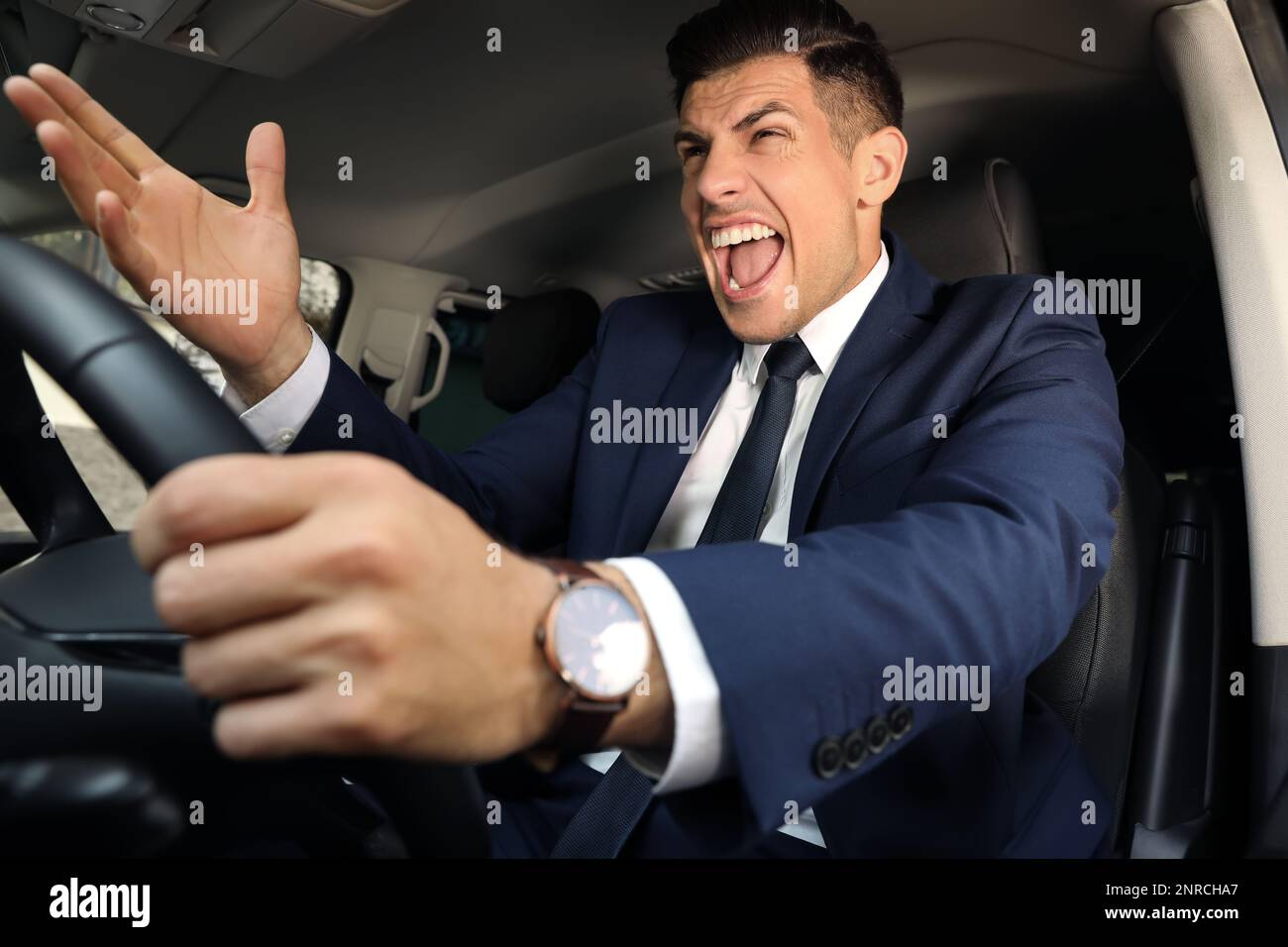 Emotional man yelling in car. Aggressive driving behavior Stock Photo ...