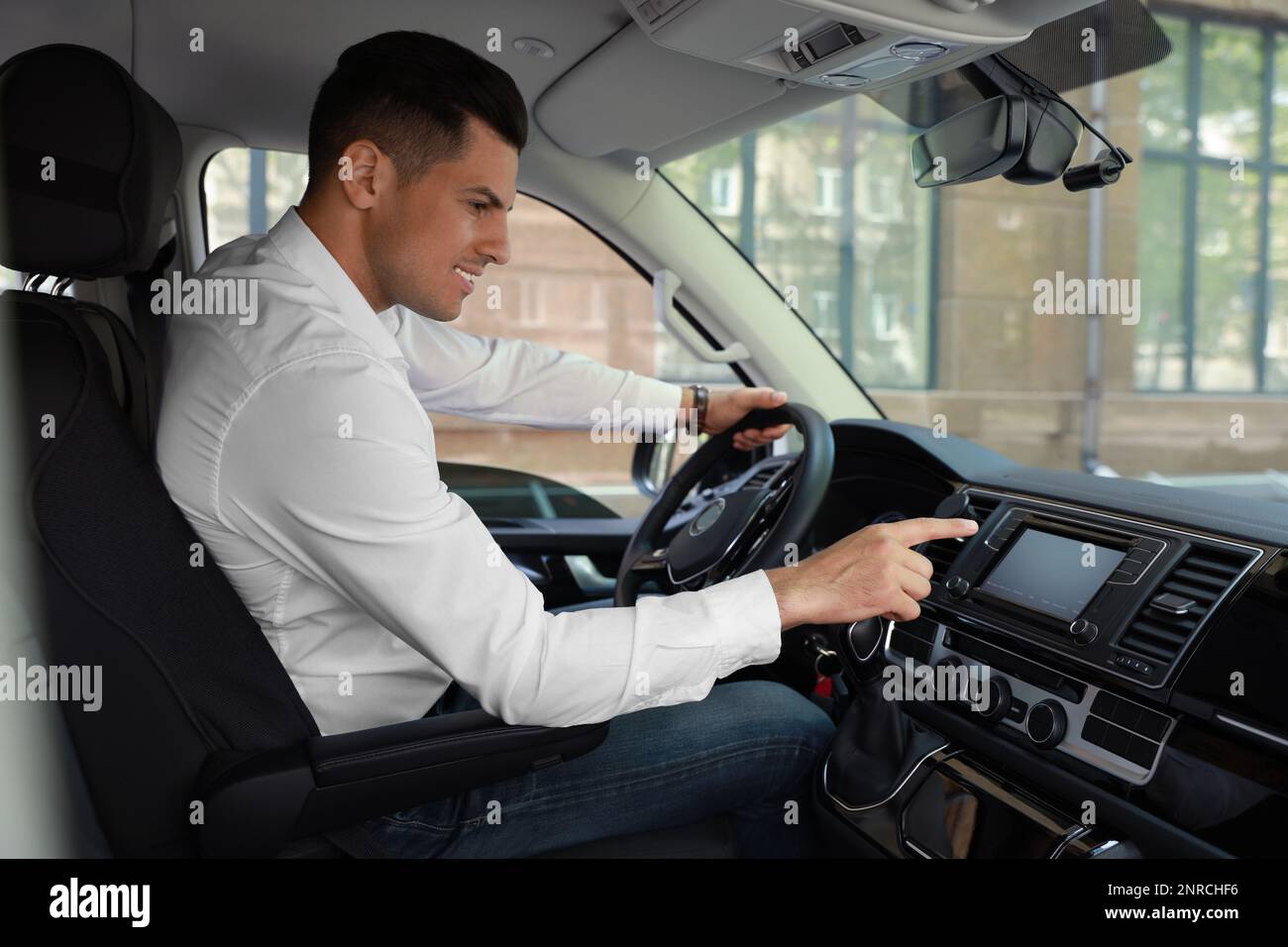 Man using navigation system while driving car Stock Photo - Alamy