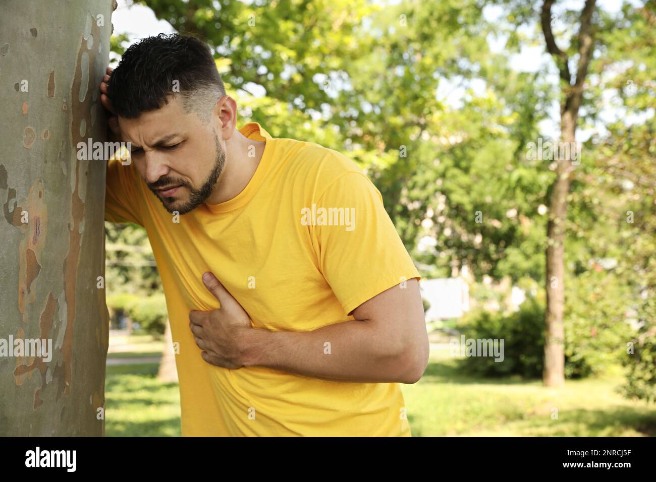 Man suffering from heat stroke in park Stock Photo - Alamy