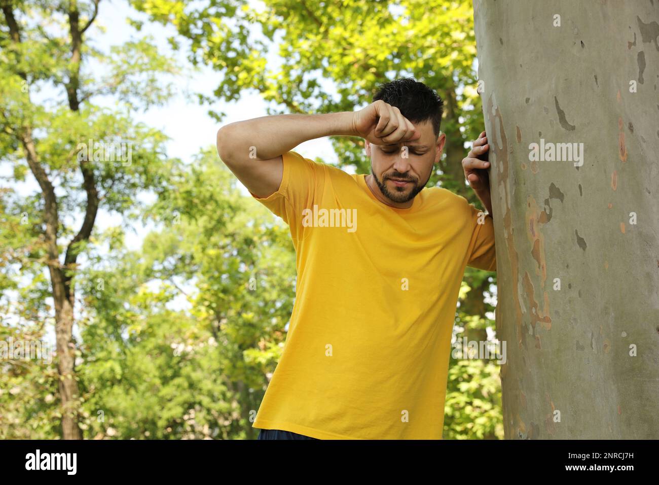 Man suffering from heat stroke in park Stock Photo - Alamy