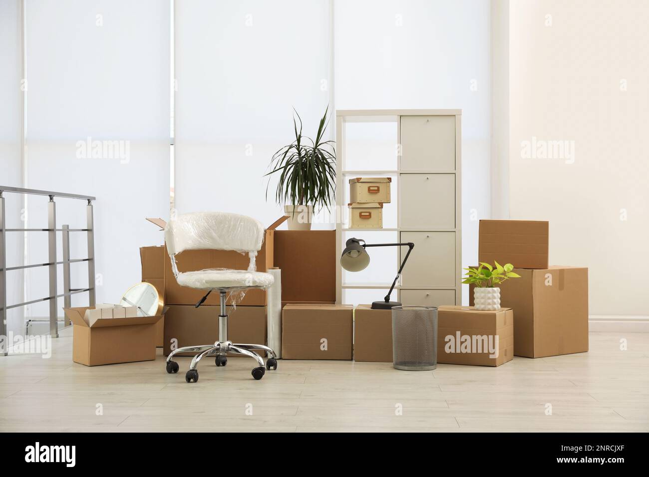 Cardboard boxes with packed stuff in new office. Moving day Stock Photo ...