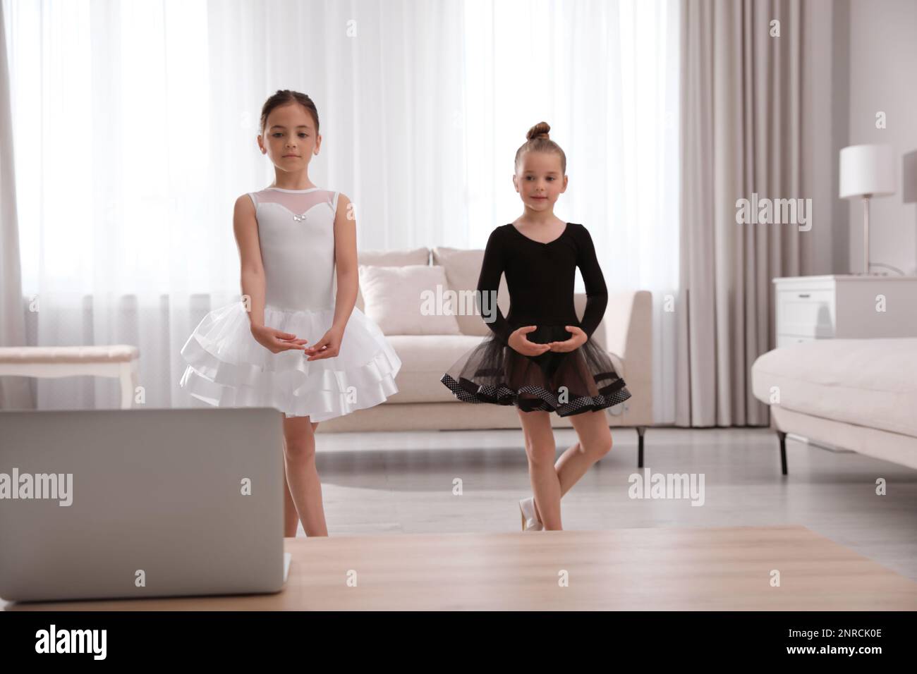 Cute little girls taking online dance class at home Stock Photo - Alamy