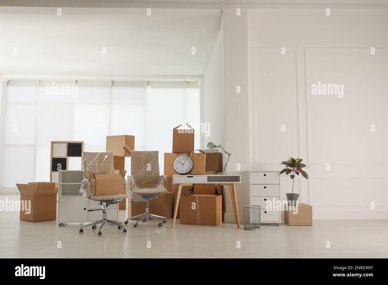 Cardboard boxes and packed stuff in office. Moving day Stock Photo - Alamy