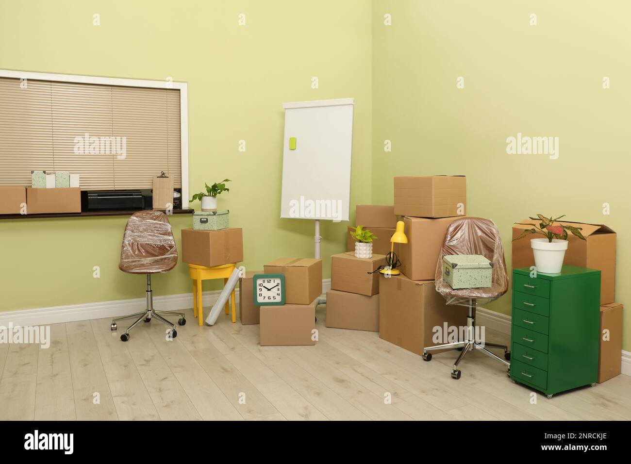 Cardboard boxes with packed stuff in new office. Moving day Stock Photo ...