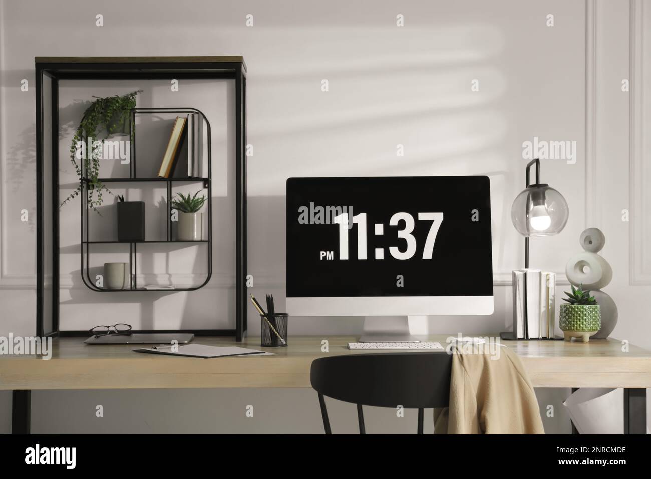 Modern computer and laptop on wooden desk in room. Interior design ...