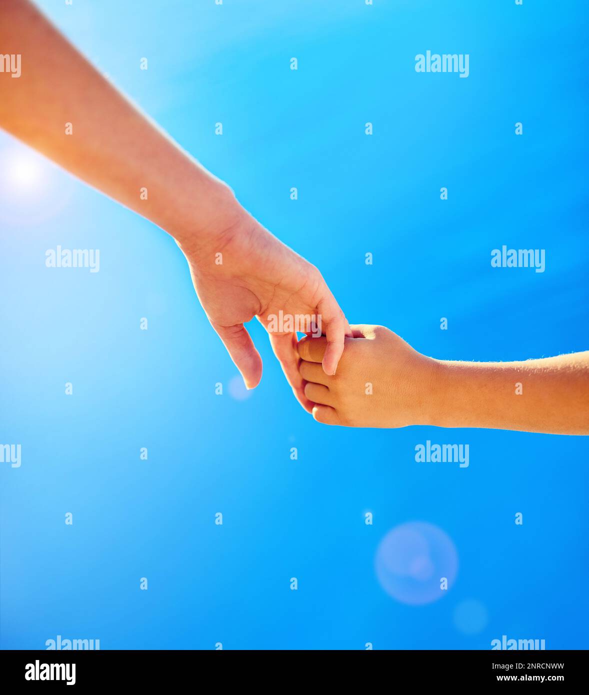 Hand in hand, side by side. Closeup shot of an adult and child holding ...