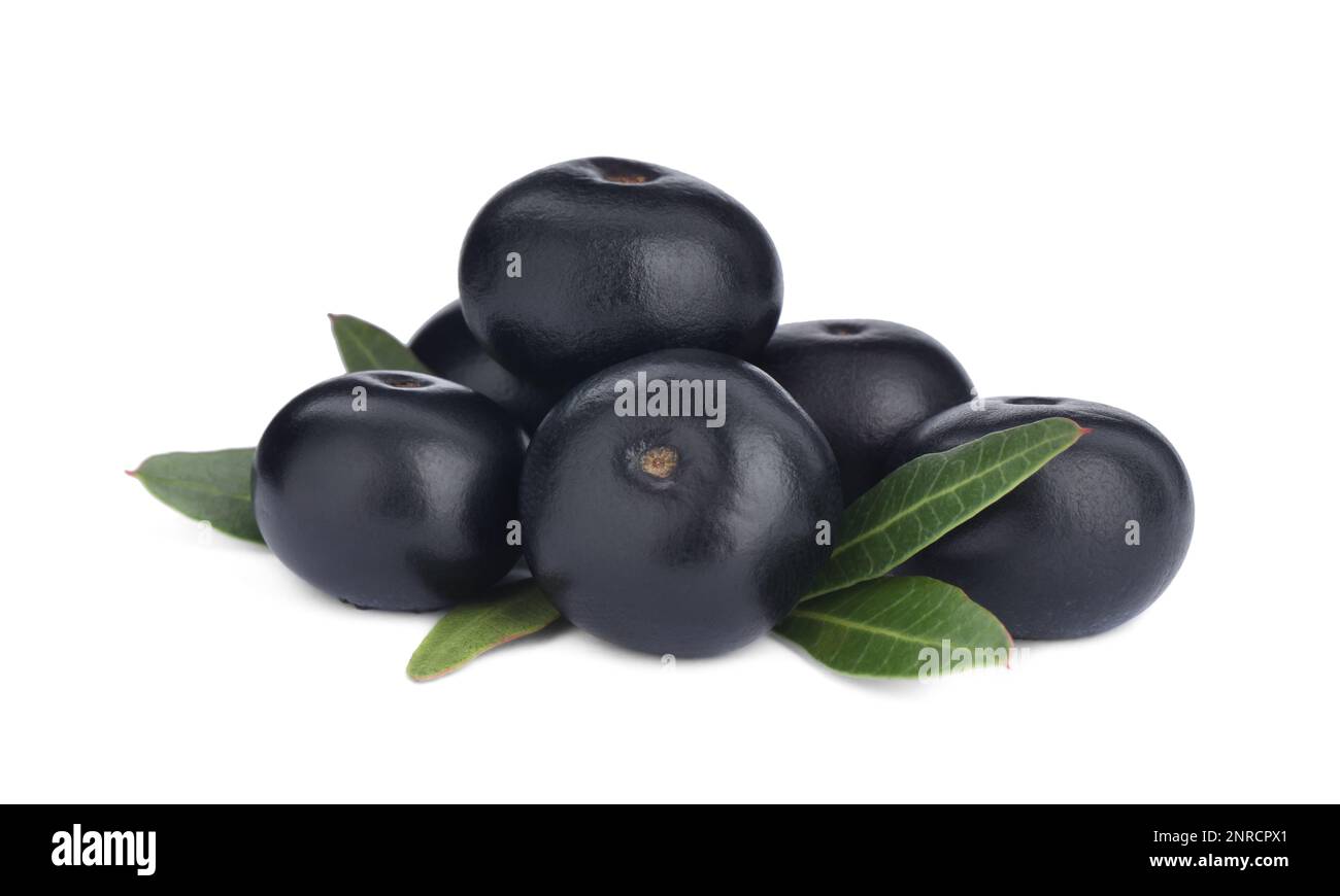 Pile of fresh ripe acai berries and green leaves on white background ...